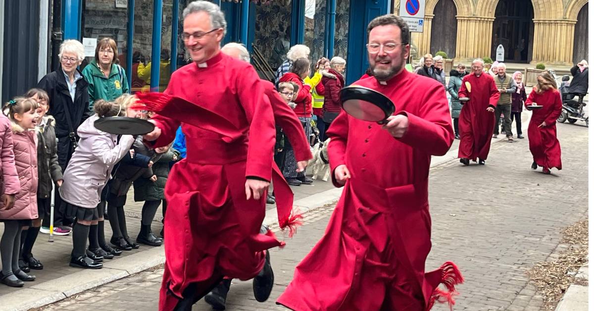 Clergy race along Kirkgate as part of Ripon's Pancake Day fun
