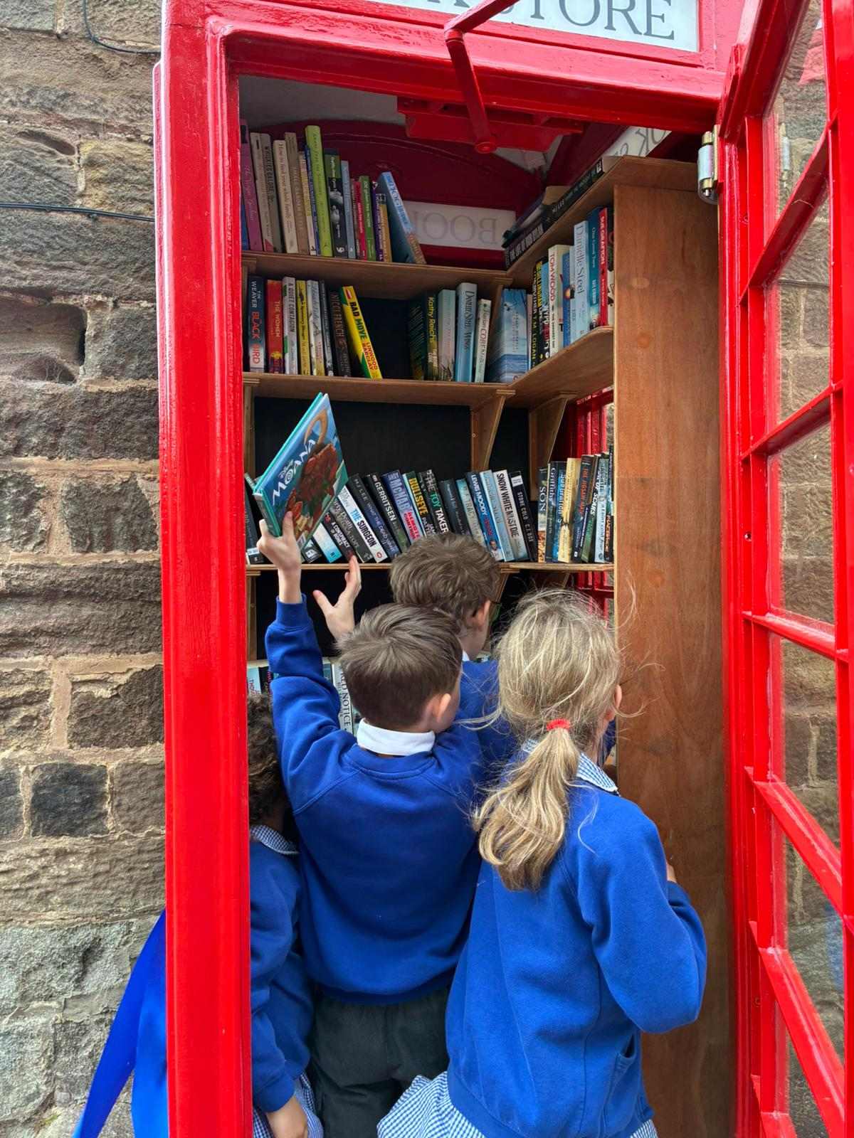 Ripley red phone box repurposed as village book swap