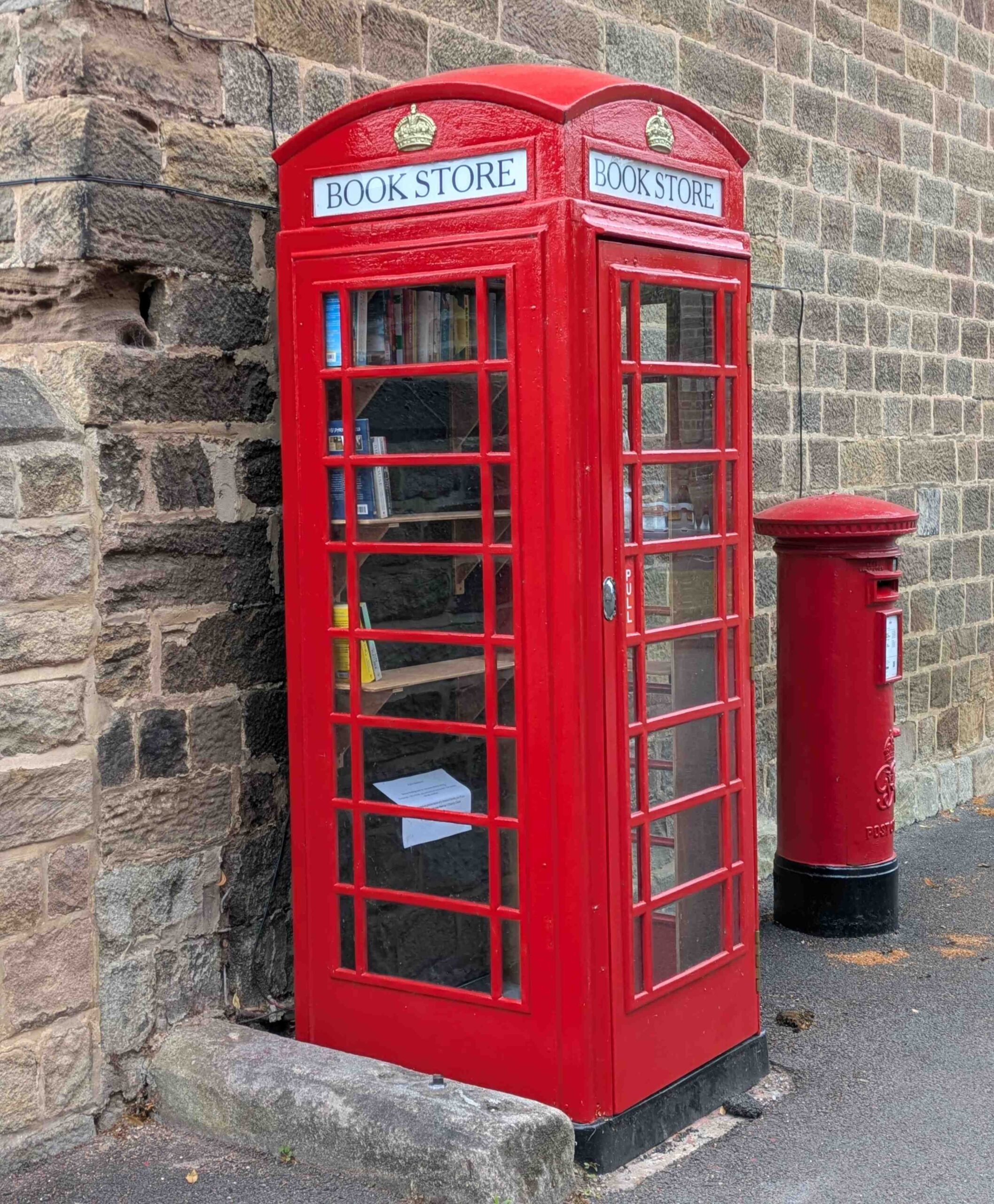 Ripley red phone box repurposed as village book swap