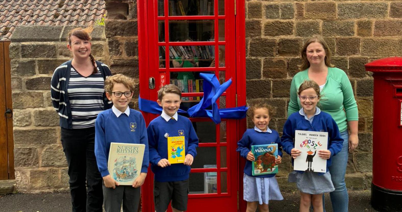 Ripley red phone box repurposed as village book swap